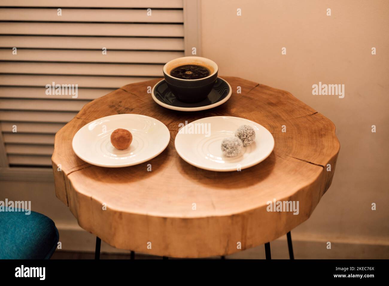 Wooden round table with coffee and desserts. Coffee break Stock Photo ...