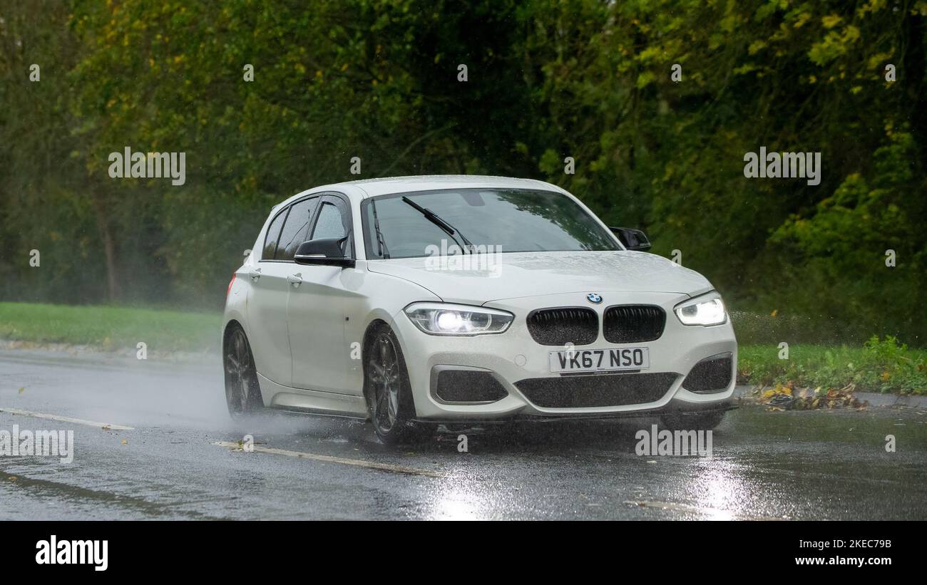 2017 white BMW 1 series car driving in the rain on a wet road Stock ...