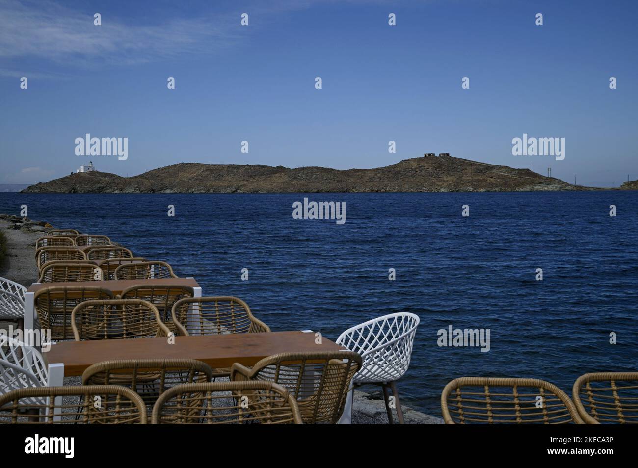 Seascape with scenic view of a traditional Greek cafe rattan furniture ...