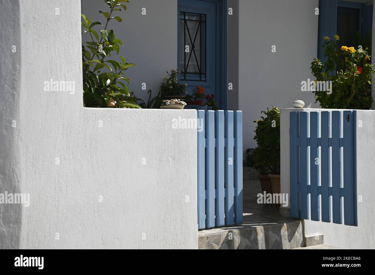Old whitewashed house with a blue wooden picket fence door in Kato ...