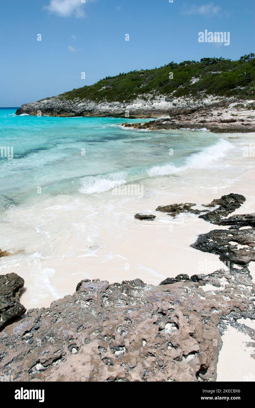 The scenic view of a tiny rocky beach with turquoise color waves on ...