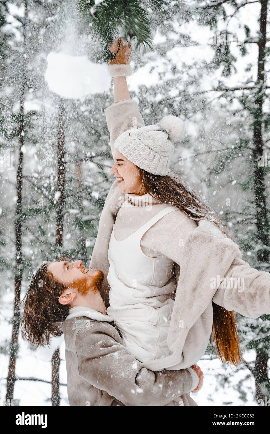 Romantic snow love story.Young couple guy girl lying,playing in snowy ...