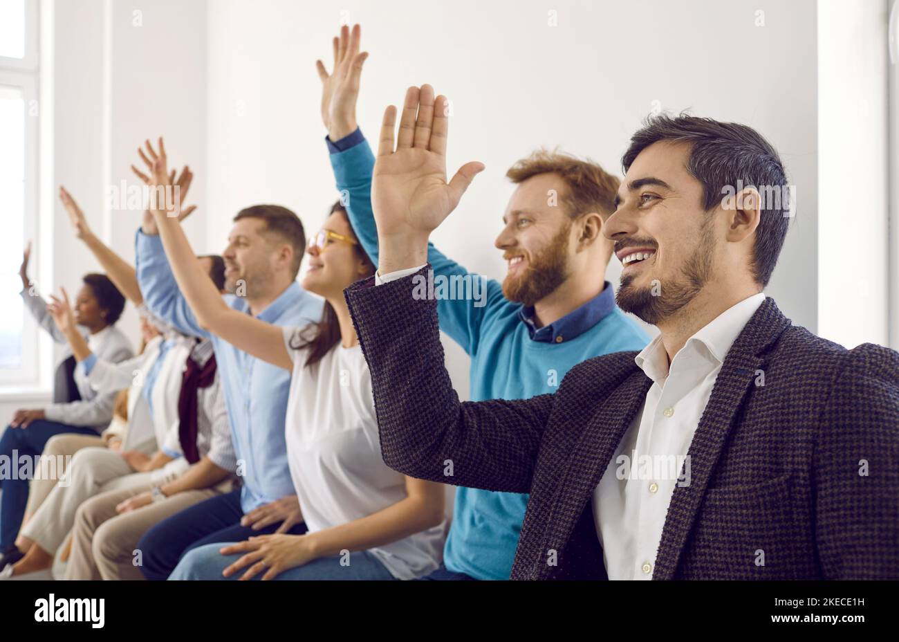 Satisfied people who want to answer questions during training seminar ...