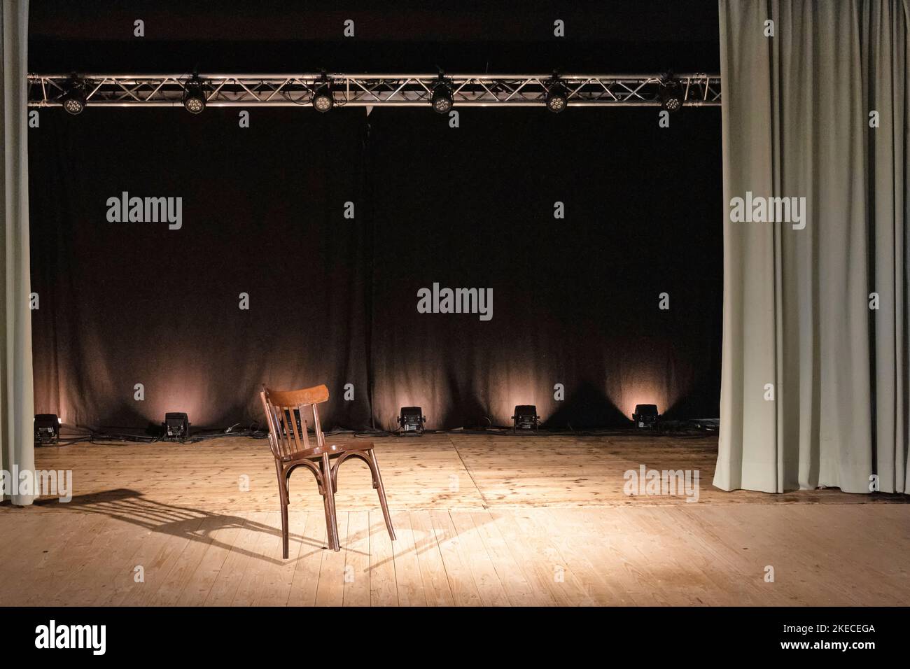 Chair on empty stage Stock Photo - Alamy
