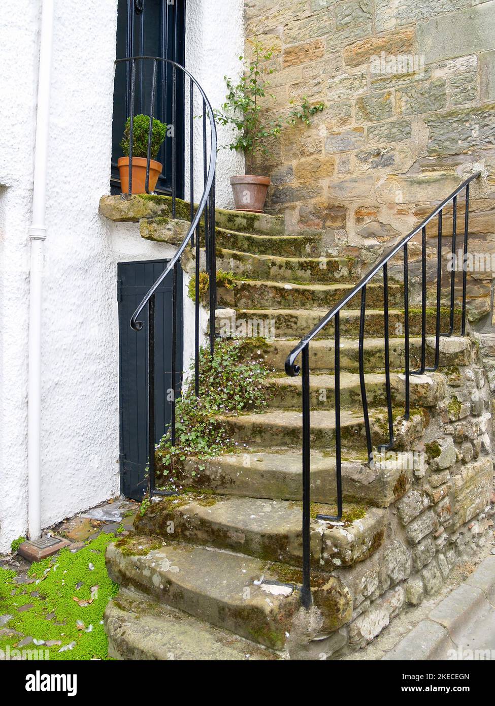Worn stone steps leading up to residential door from street below Stock ...