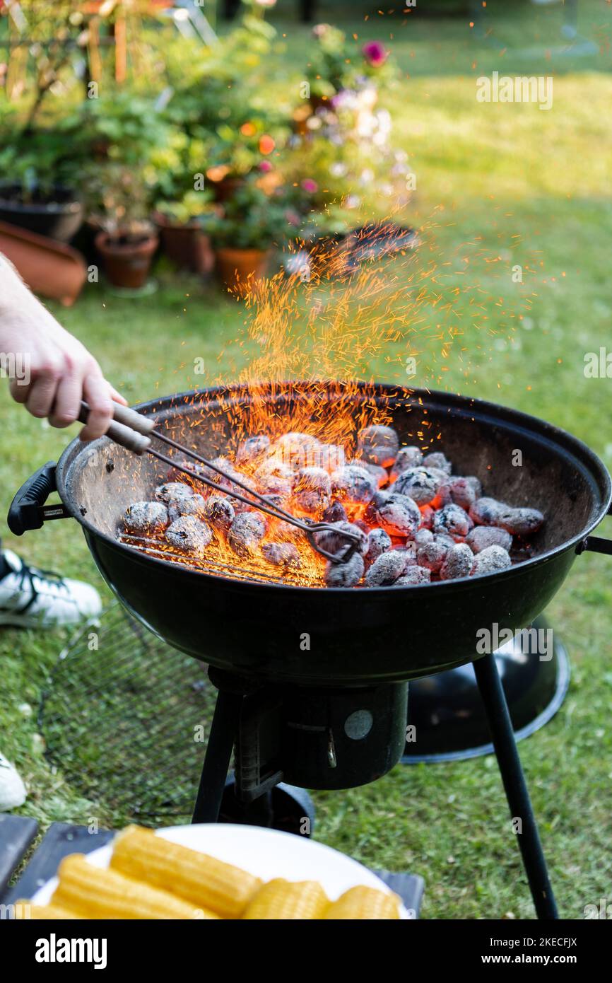 A vertical closeup of a barbecue grill with a burning charcoal Stock ...