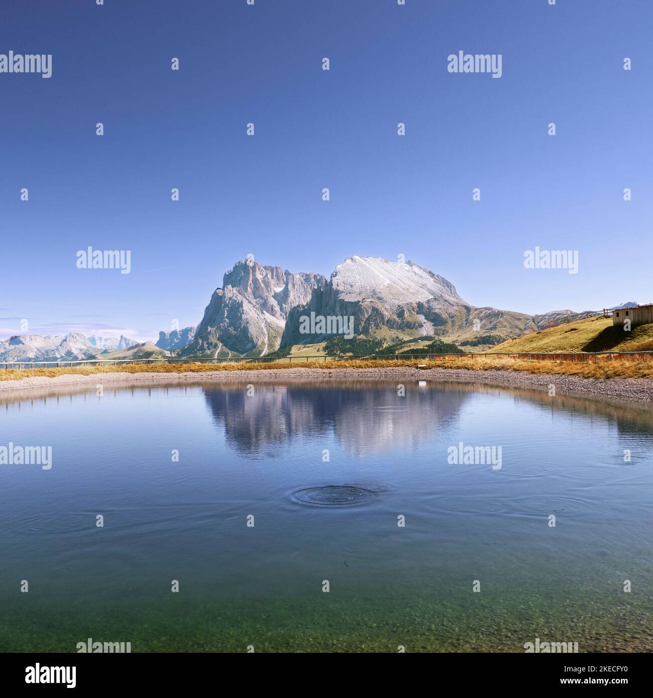 The Sassolungo group reflected in the water reservoir at the Edelweiss ...