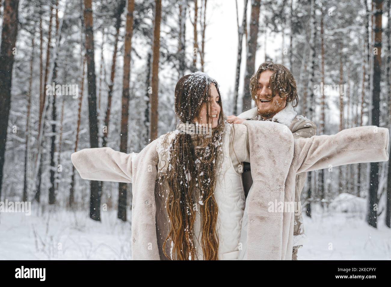 Romantic snow love story.Young couple guy girl lying,playing in snowy ...
