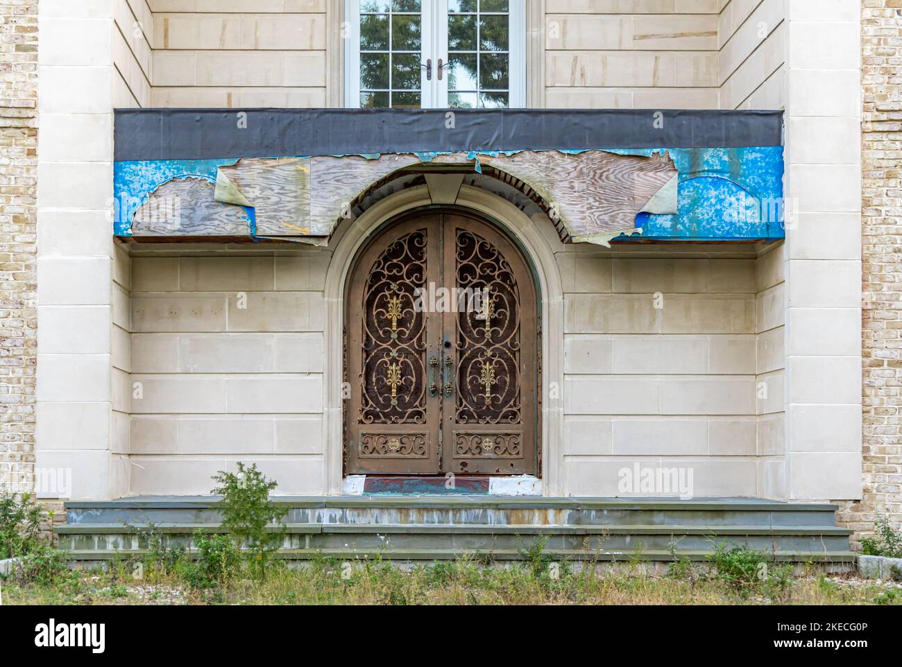 A pair of elaborate arched metal doors in an unfinished project Stock ...