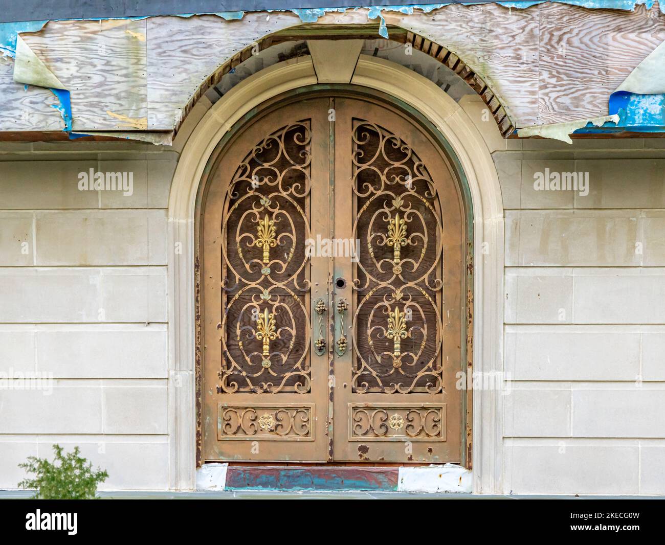 A pair of elaborate arched metal doors in an unfinished project Stock ...