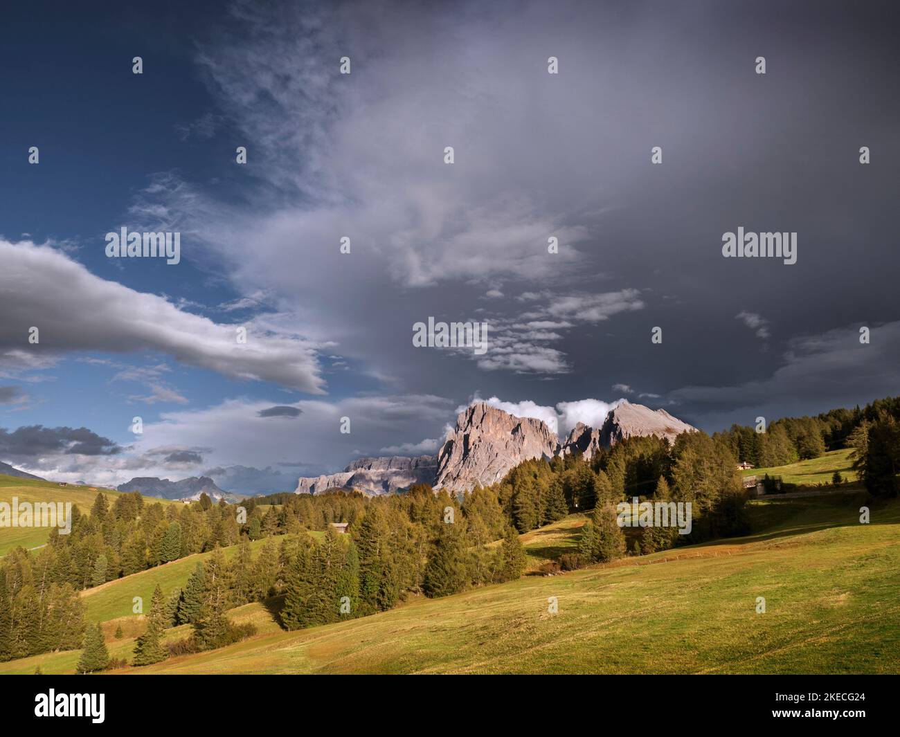 Alpe di Siusi with rising rain clouds and low sun with view towards the ...