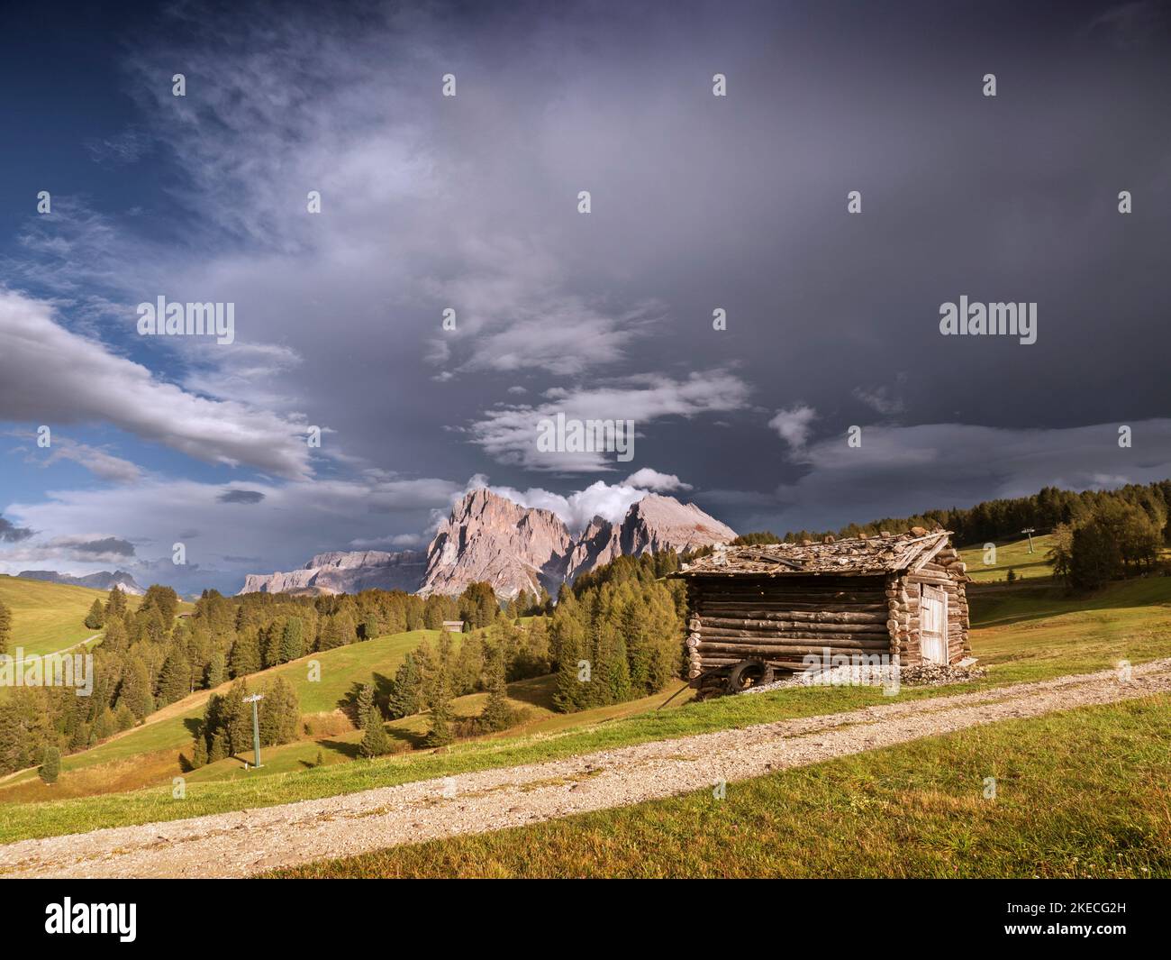 Alpe di Siusi with rising rain clouds and low sun with view towards the ...