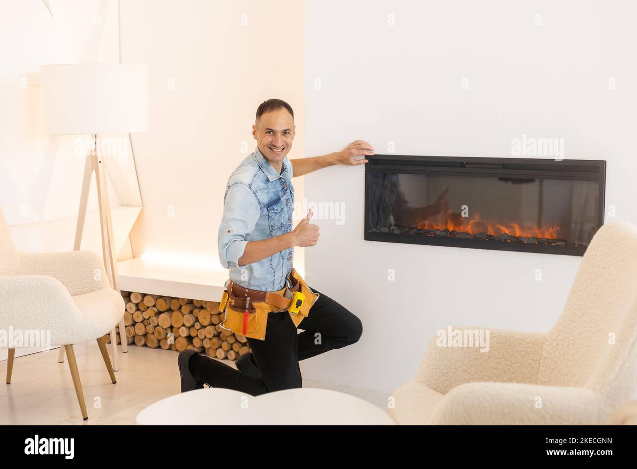 Professional technician installing electric fireplace in room Stock ...