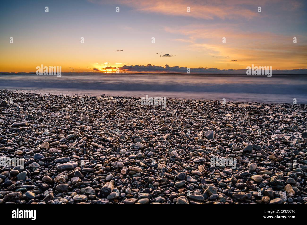 A scenic shot of the Hokitika beach in New Zealand at sunset with ...