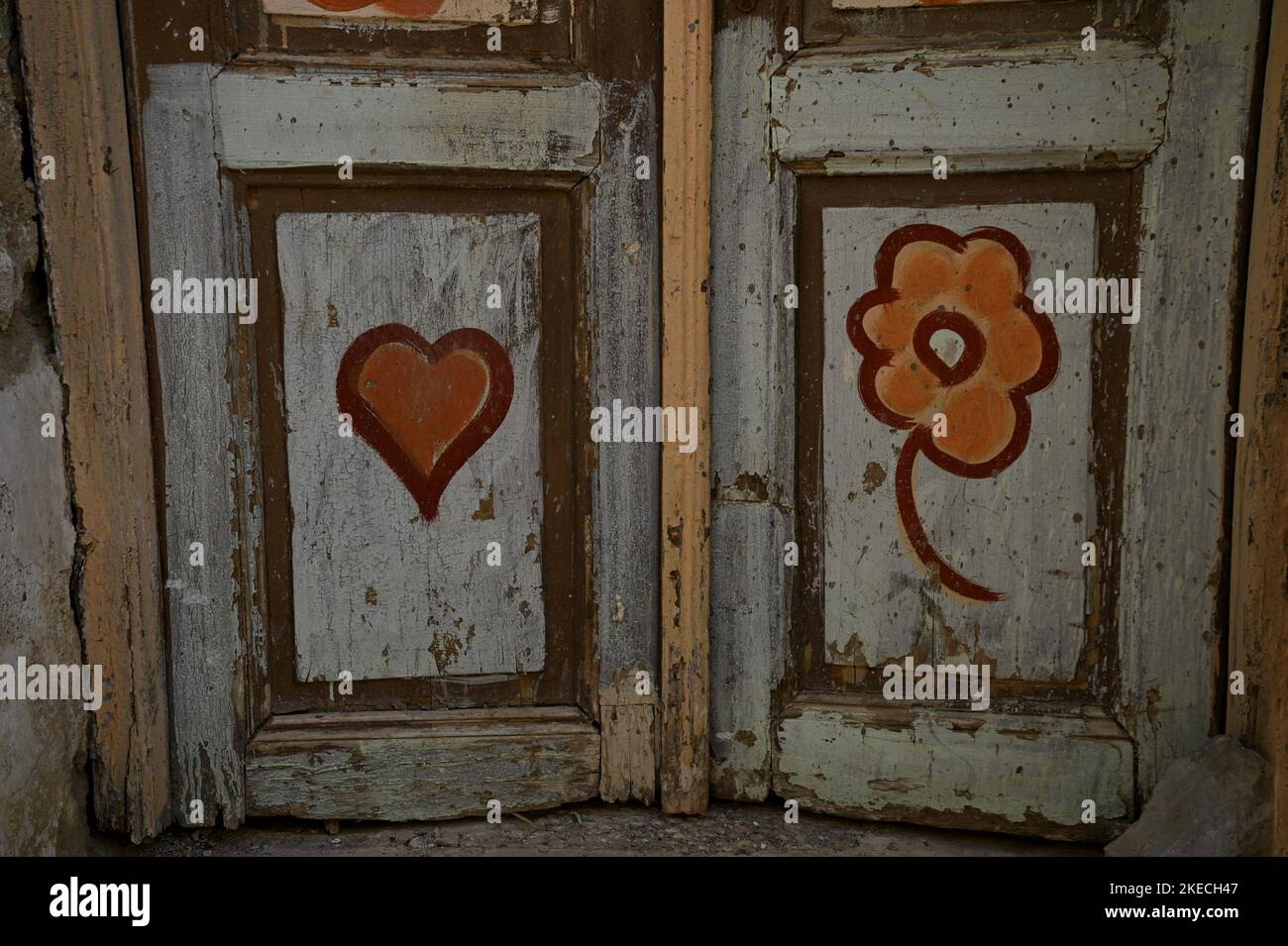 Traditional hand painted antique wooden window against a stone wall in ...