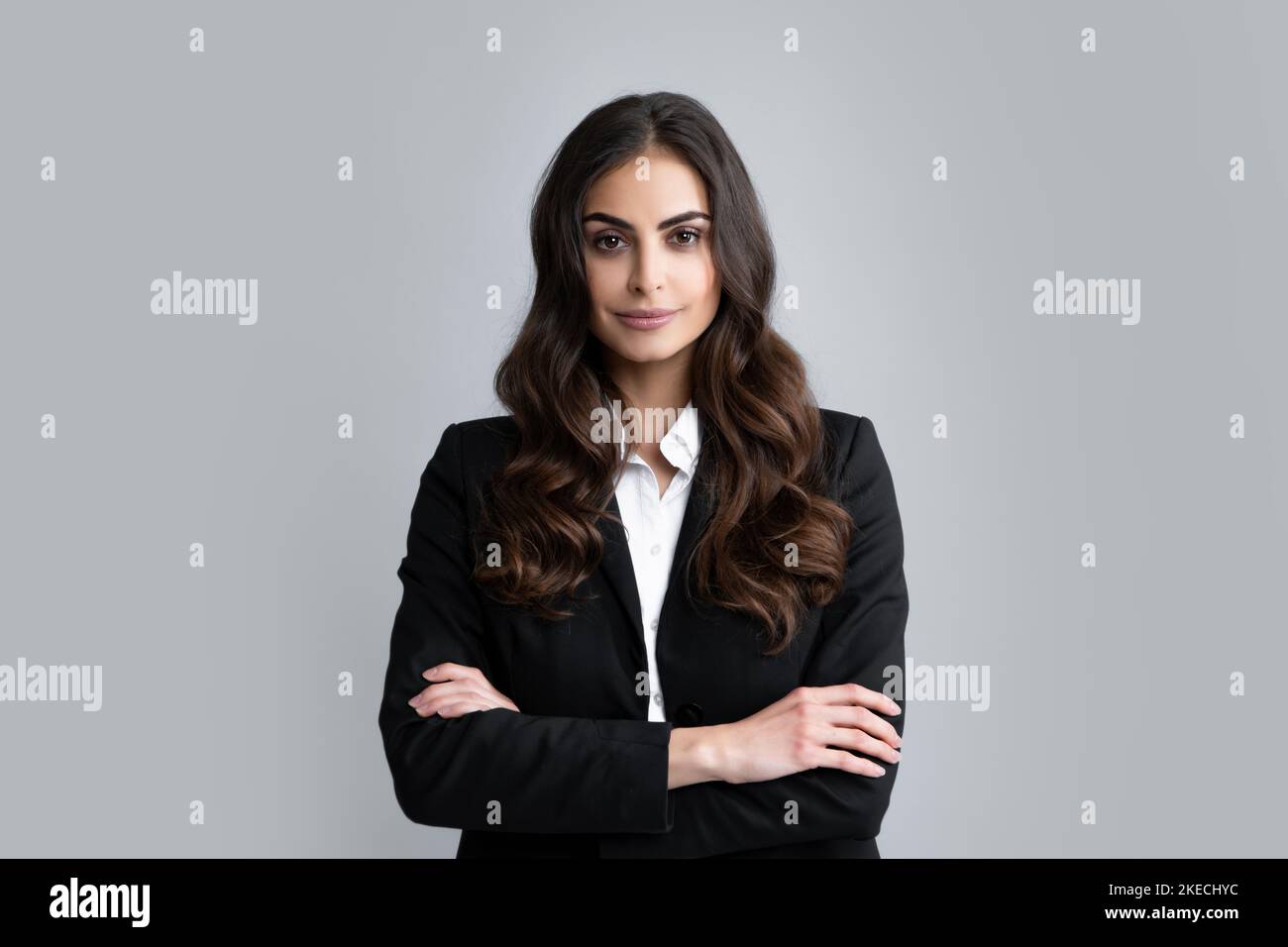 Portrait of successful business woman in suit on gray isolated ...