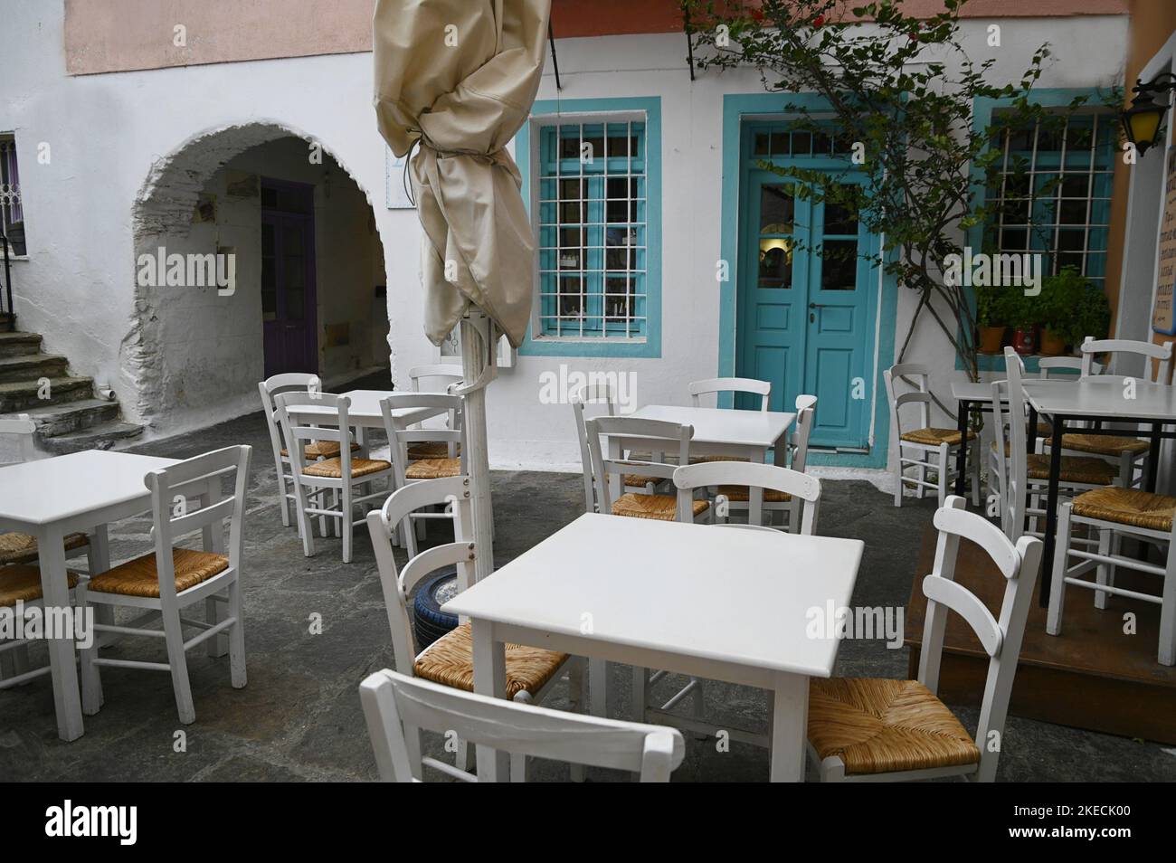Traditional rural cafe patio with colorful bistro furniture in Kea ...