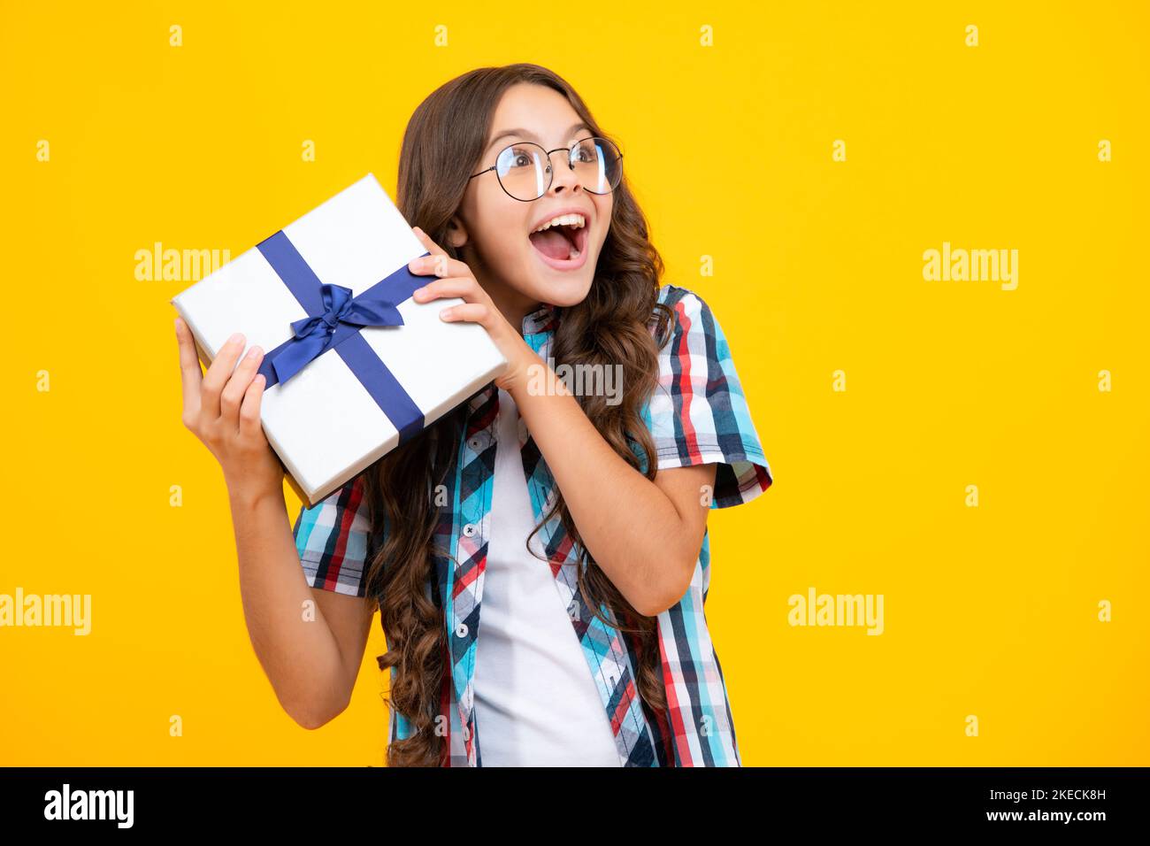 Amazed teen girl. Teenager kid with present box. Teen girl giving ...