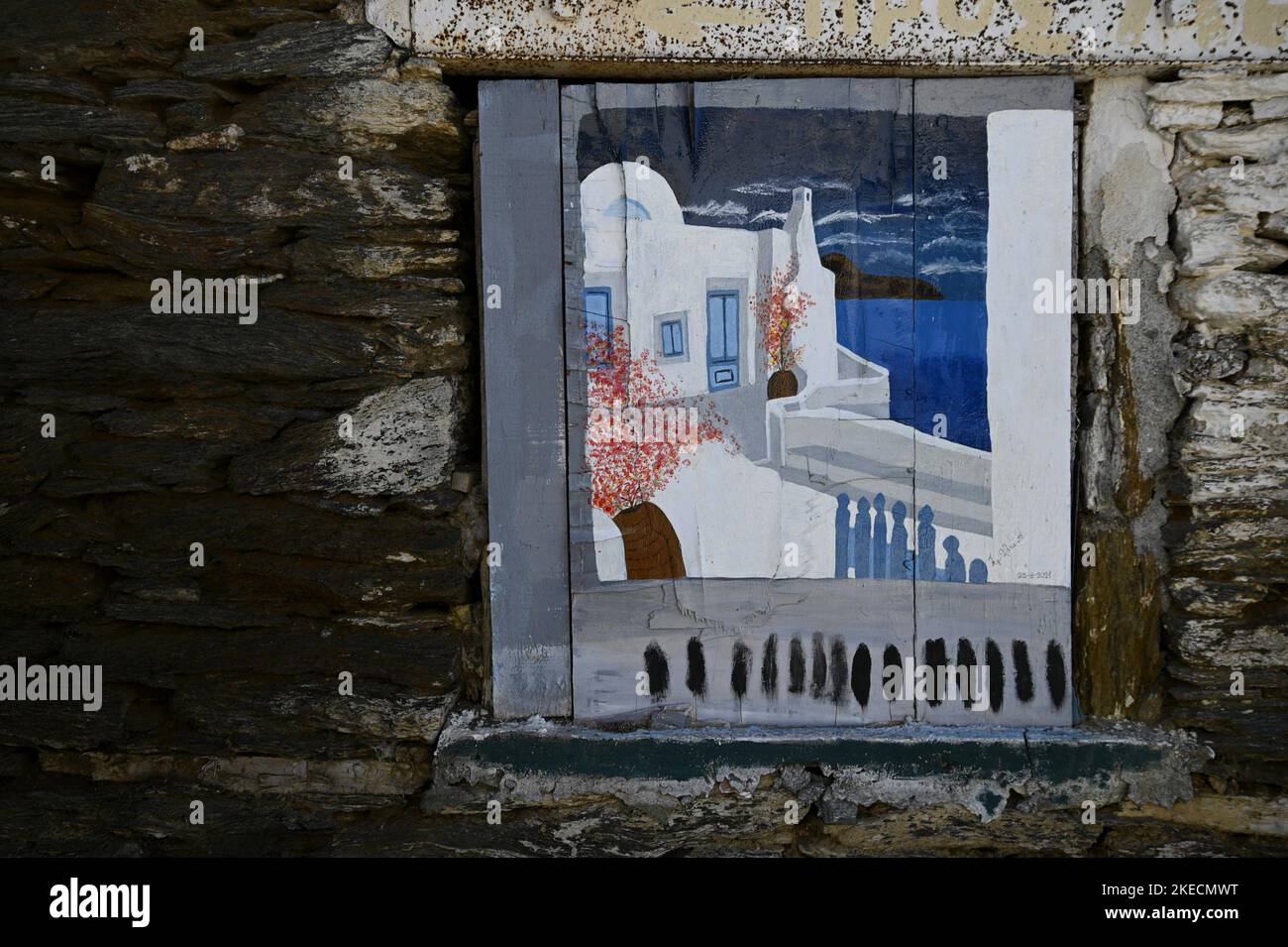 Traditional hand painted antique wooden window against a stone wall in ...