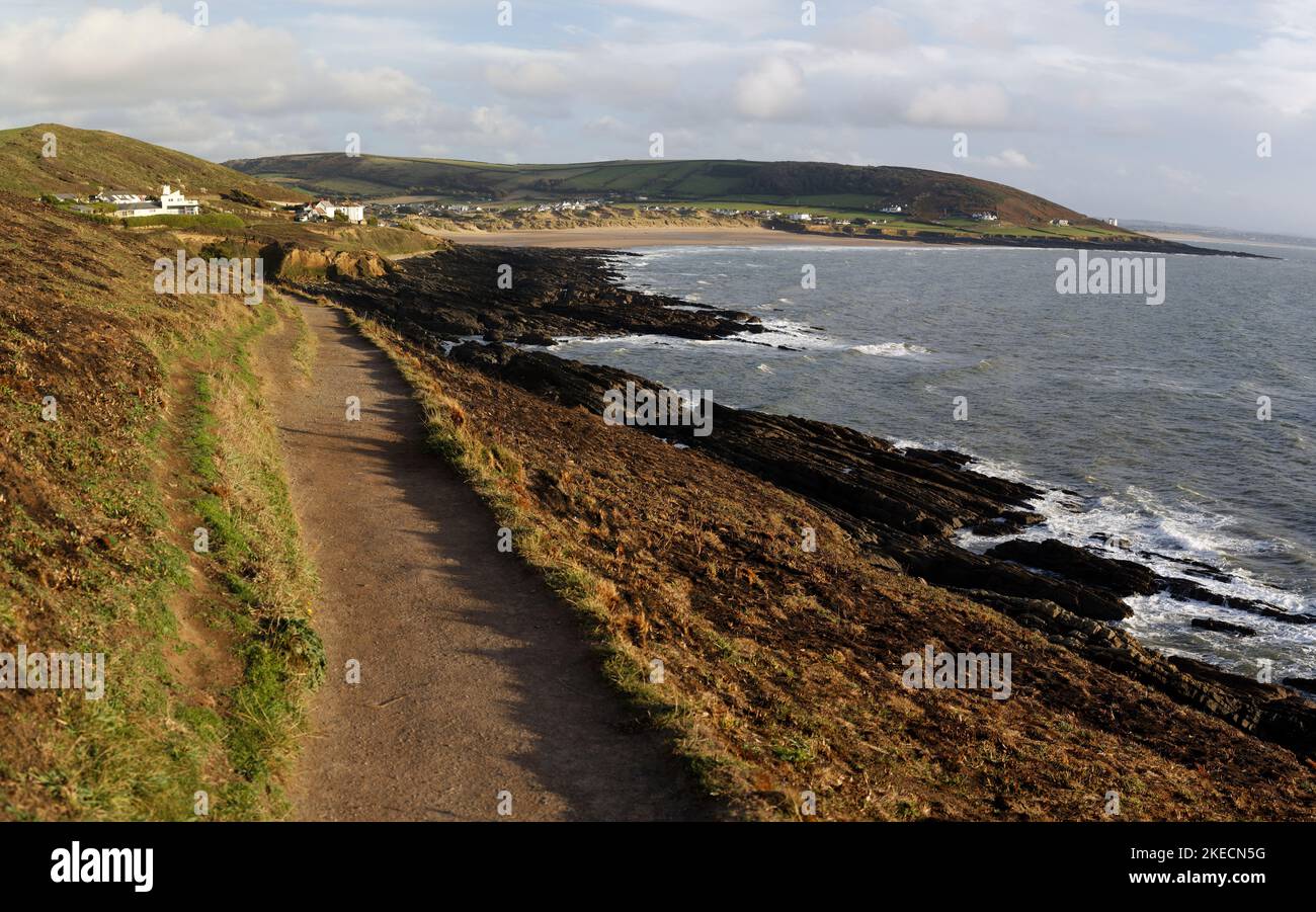 View to Croyde Beach from Baggy Point bathed in eveing sun North Devon ...