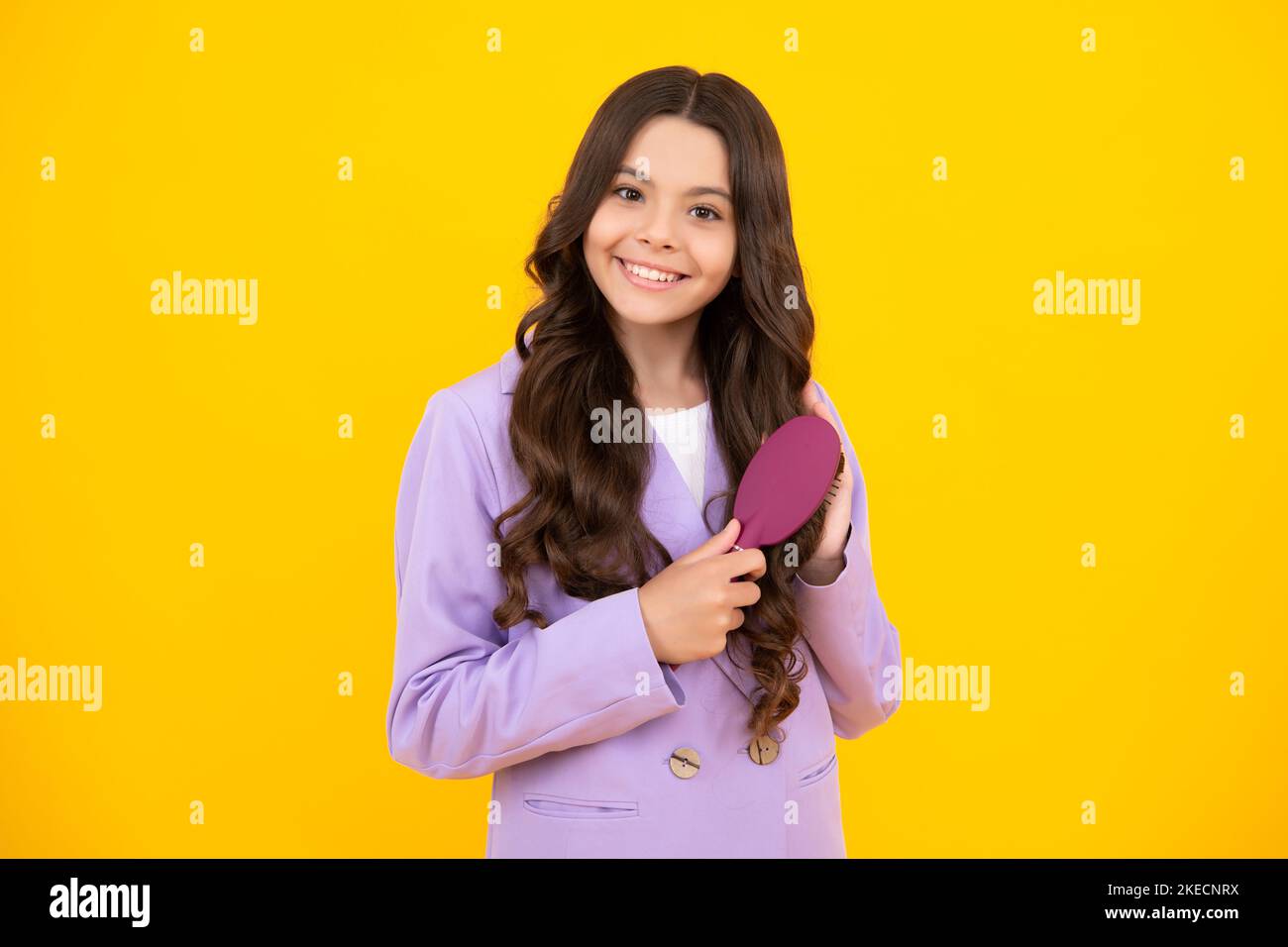 Teenage girl with brush combing hair. Girl taking hairstyle. Child ...