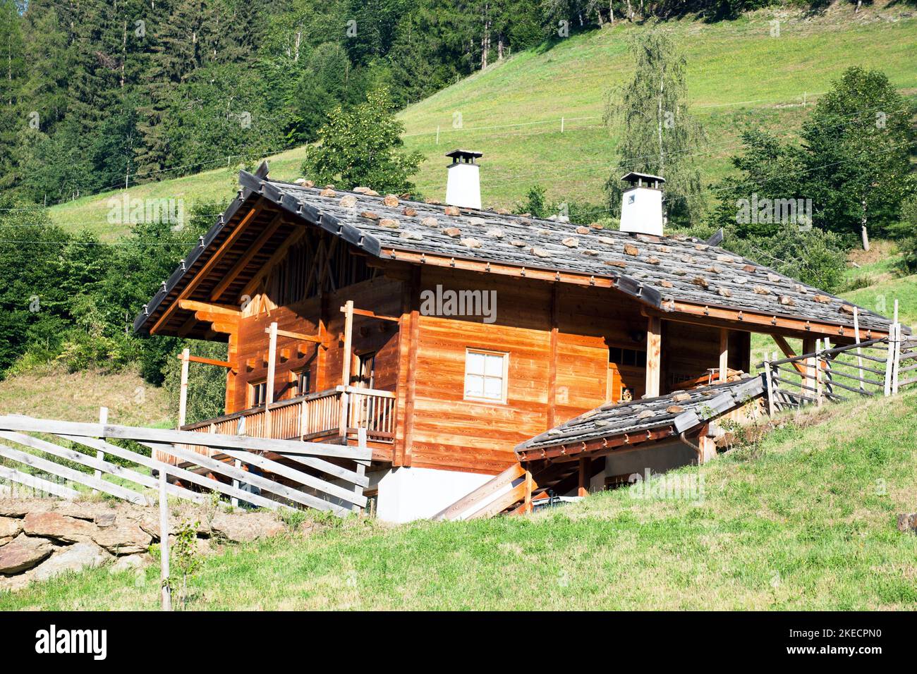 New construction of a mountain farm in typical country style on steep ...