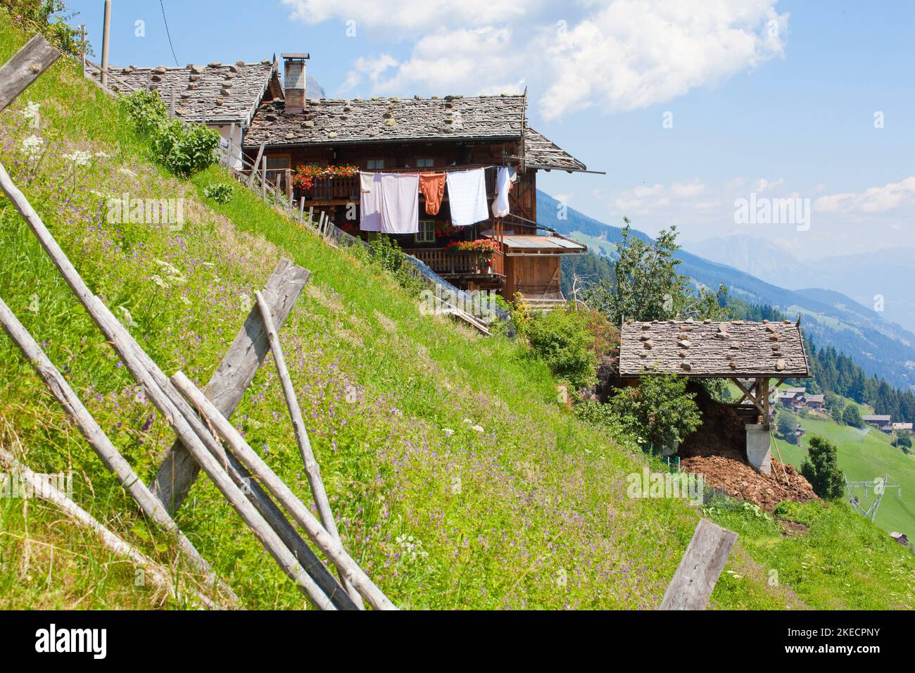 Mountain farms on the steep slope high above the valley floor in the ...