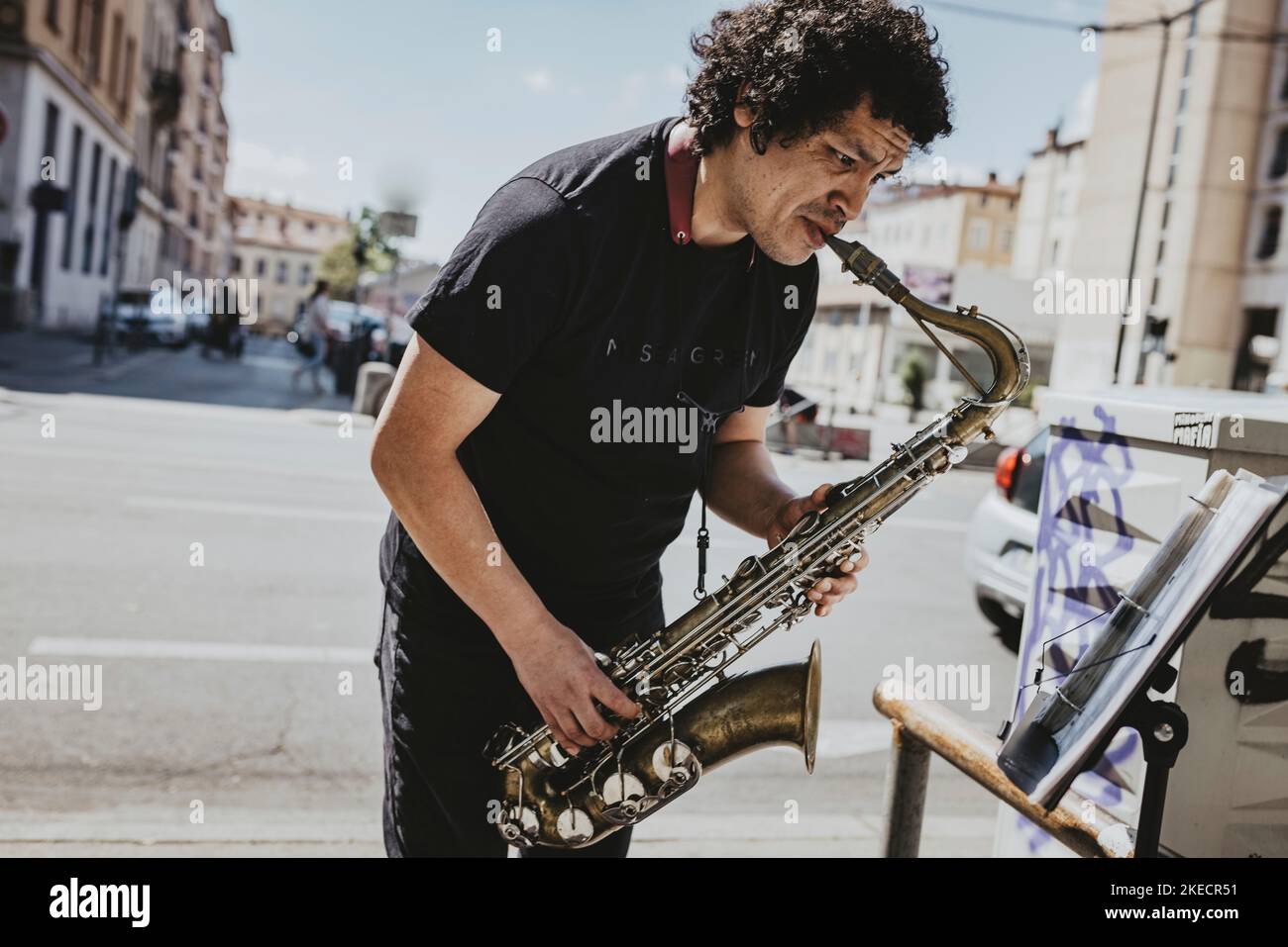 Man playing saxophone in downtown Stock Photo - Alamy