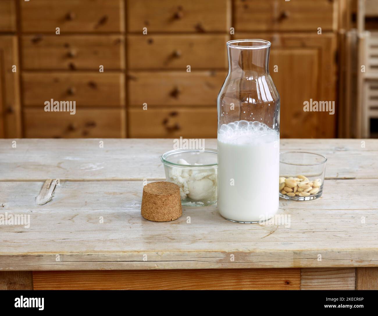 Steps for making almond milk, finished almond milk in a glass bottle ...