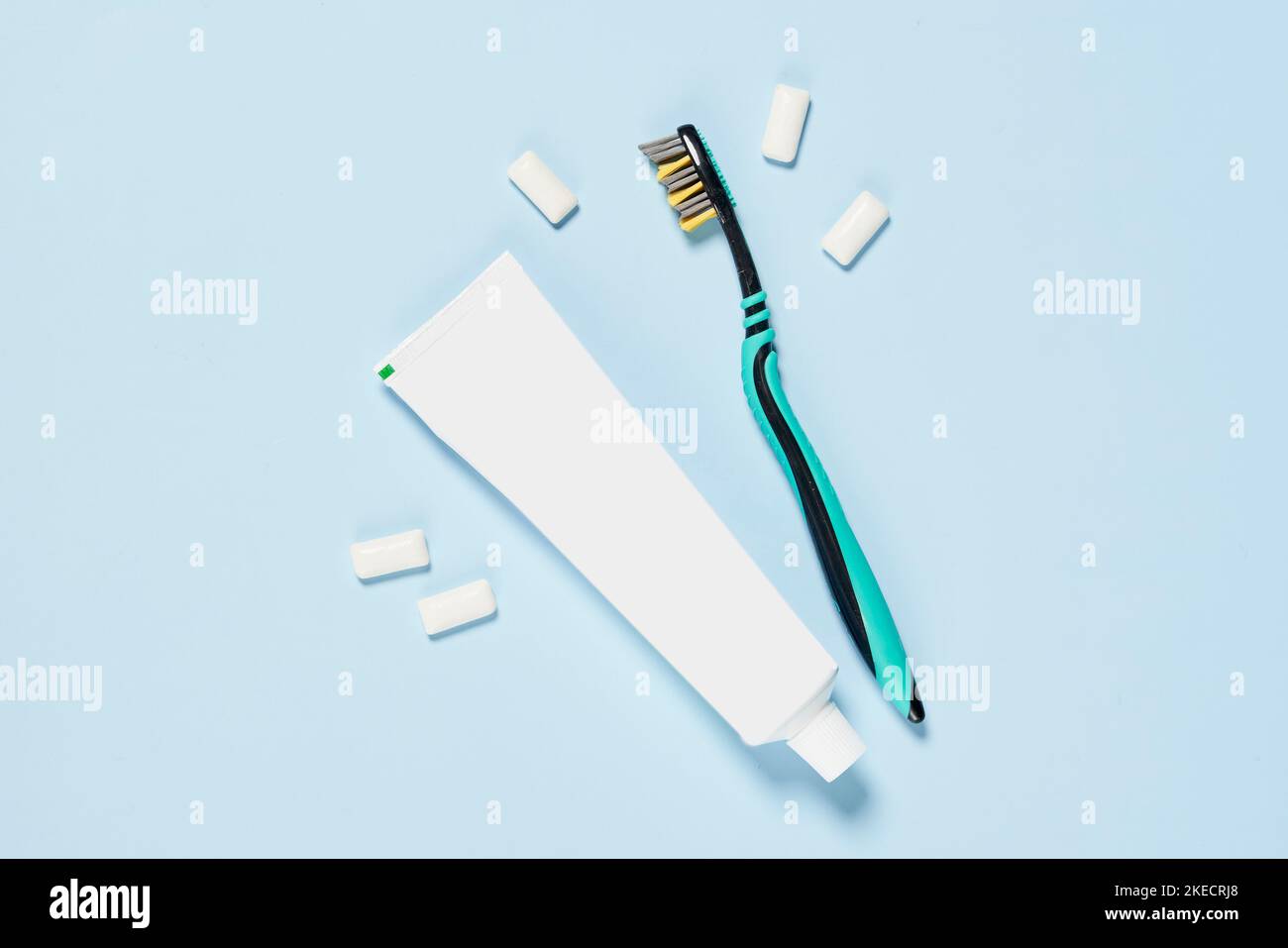 a toothbrush and some pieces of paper on a light blue background with ...