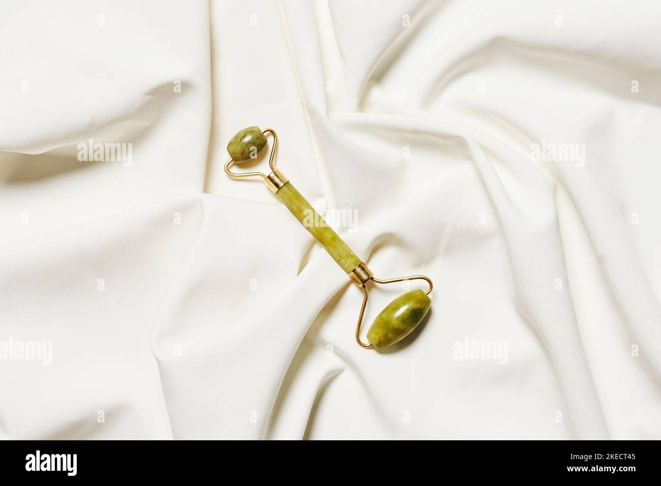 a green object on a white cloth with an arrow in it's middle and the ...