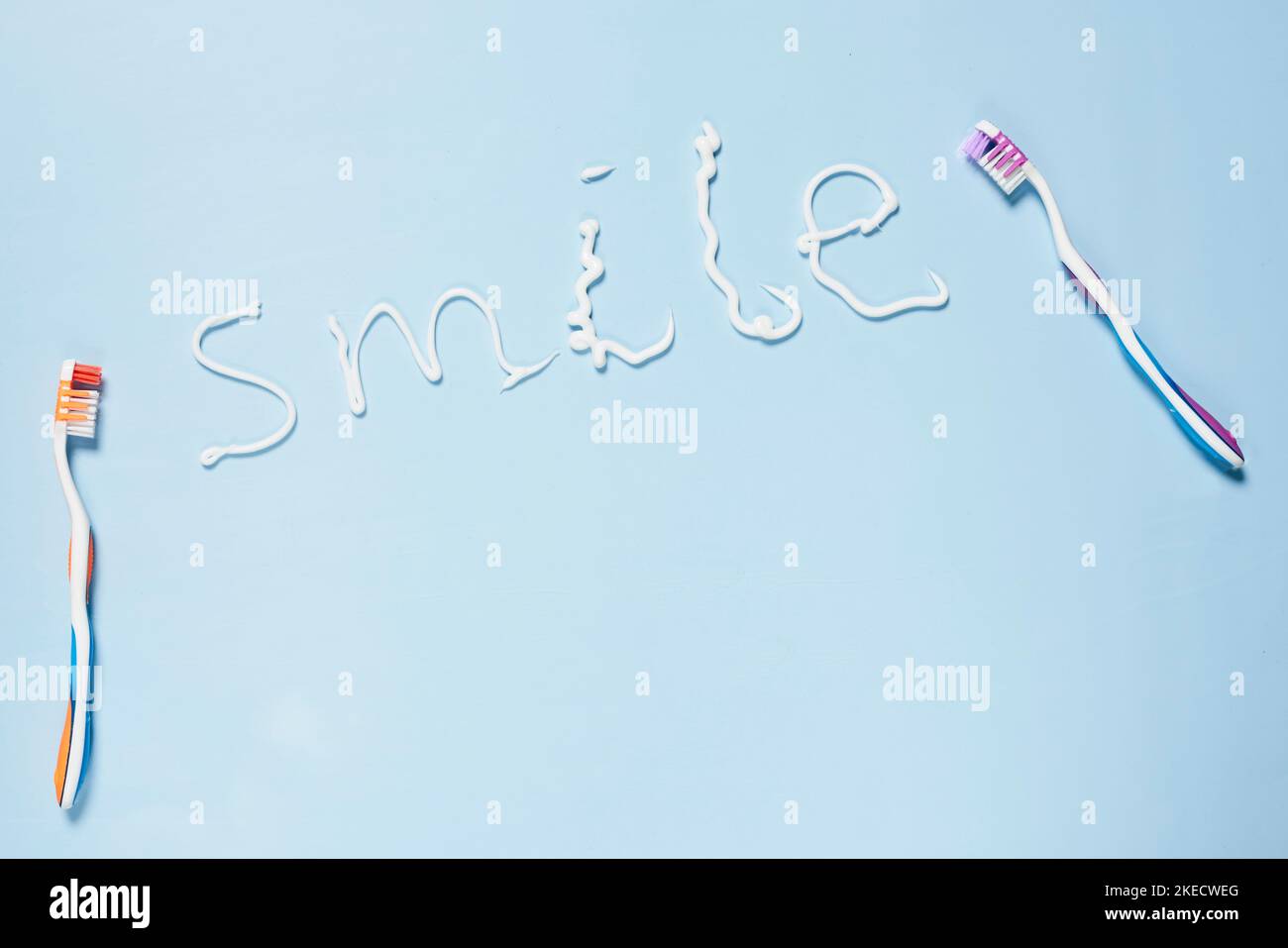tooths and the word smile written in white paint on a light blue ...