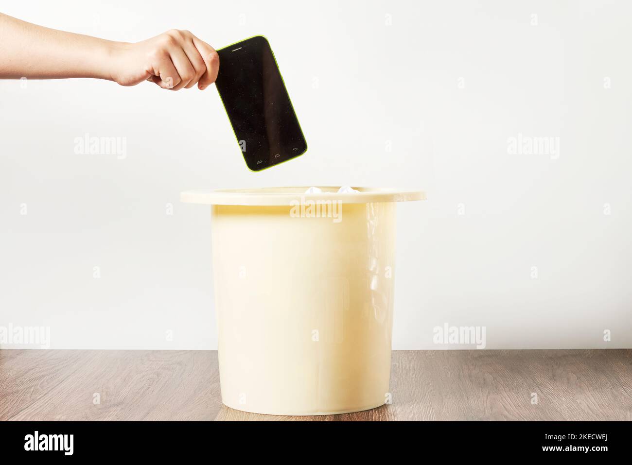 someone throwing a cell into a trash can to make it look like an iphone ...