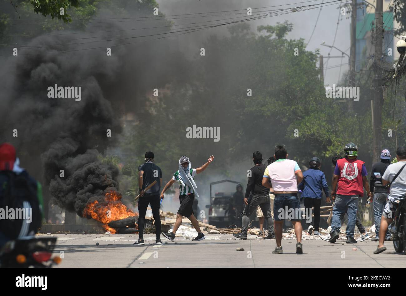 Santa Cruz, Bolivia. 11th Nov, 2022. Hooded demonstrators burn tires ...