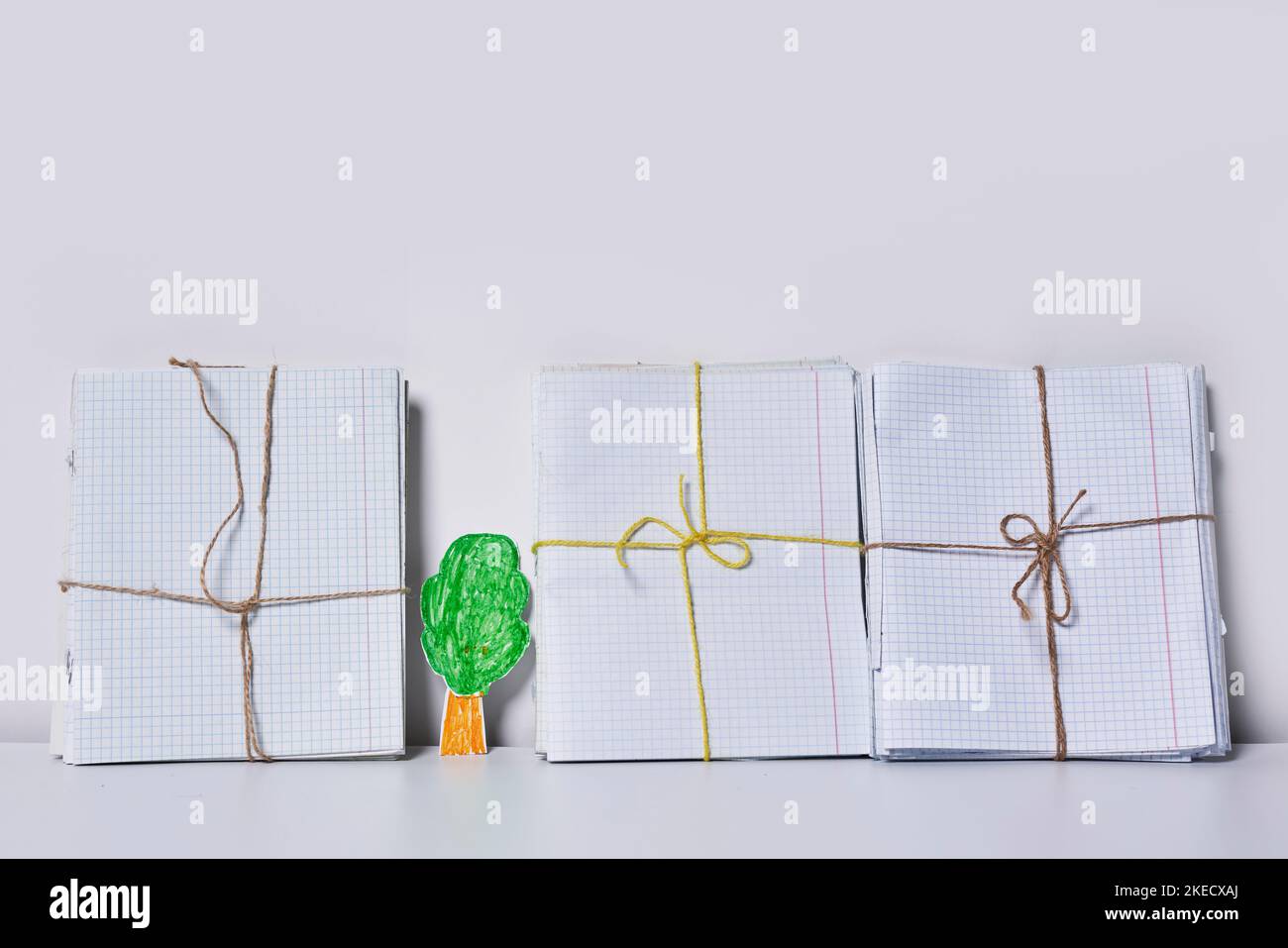 three notebooks wrapped in twine and tied to each other one with a ...