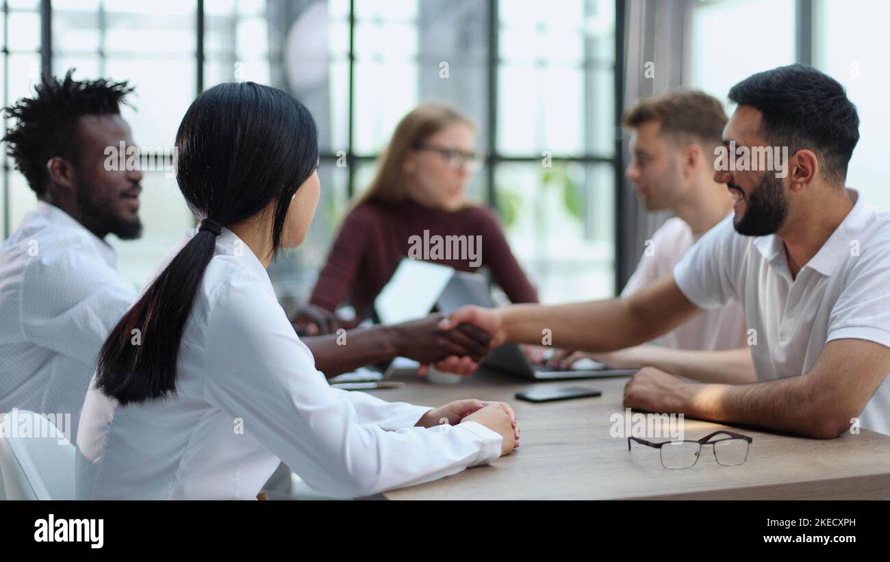 Welcome to our team. Handshake while working in a creative office. Success concept Stock Photo ...