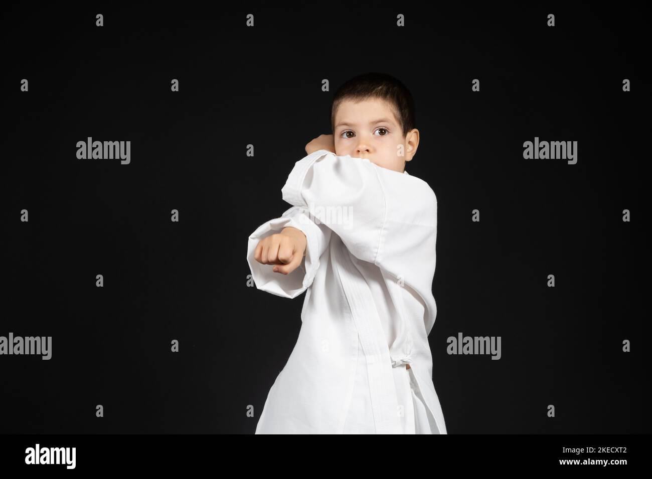 A little boy practices martial arts, karate classes in kimono on a ...