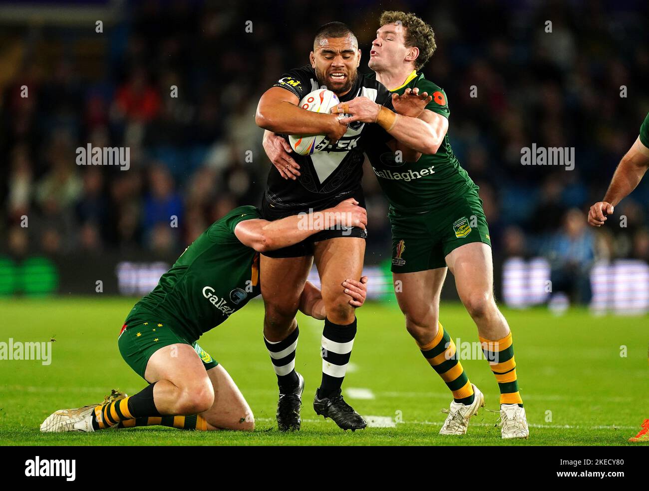 New Zealand's Isaiah Papali'I (centre) is tackled by Australia's Isaah ...