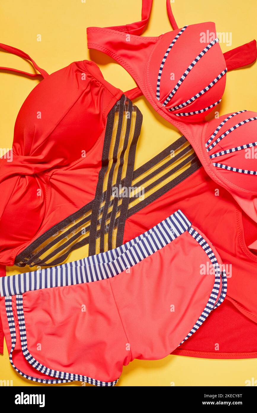 red swimsuits on a yellow background, with blue and white striped bands ...