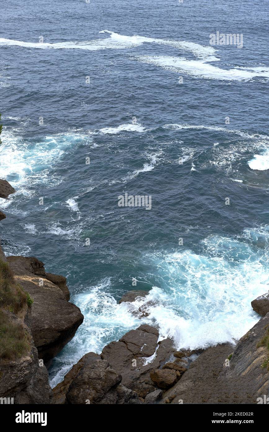 A lighthouse on the Cantabrian Sea coast, and coast line, Calm waters ...