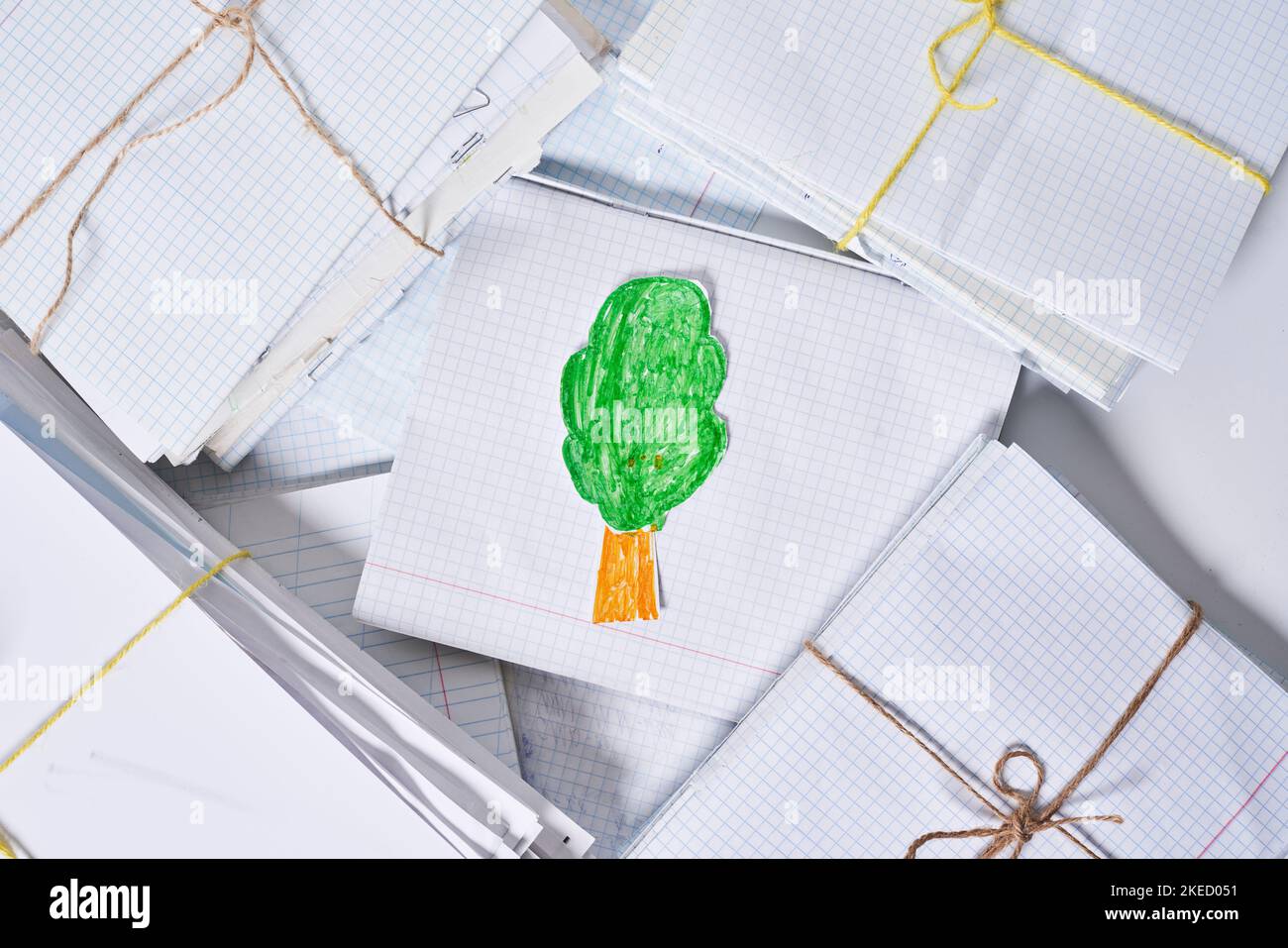 a green tree on top of several white boxes with string wrapped around ...