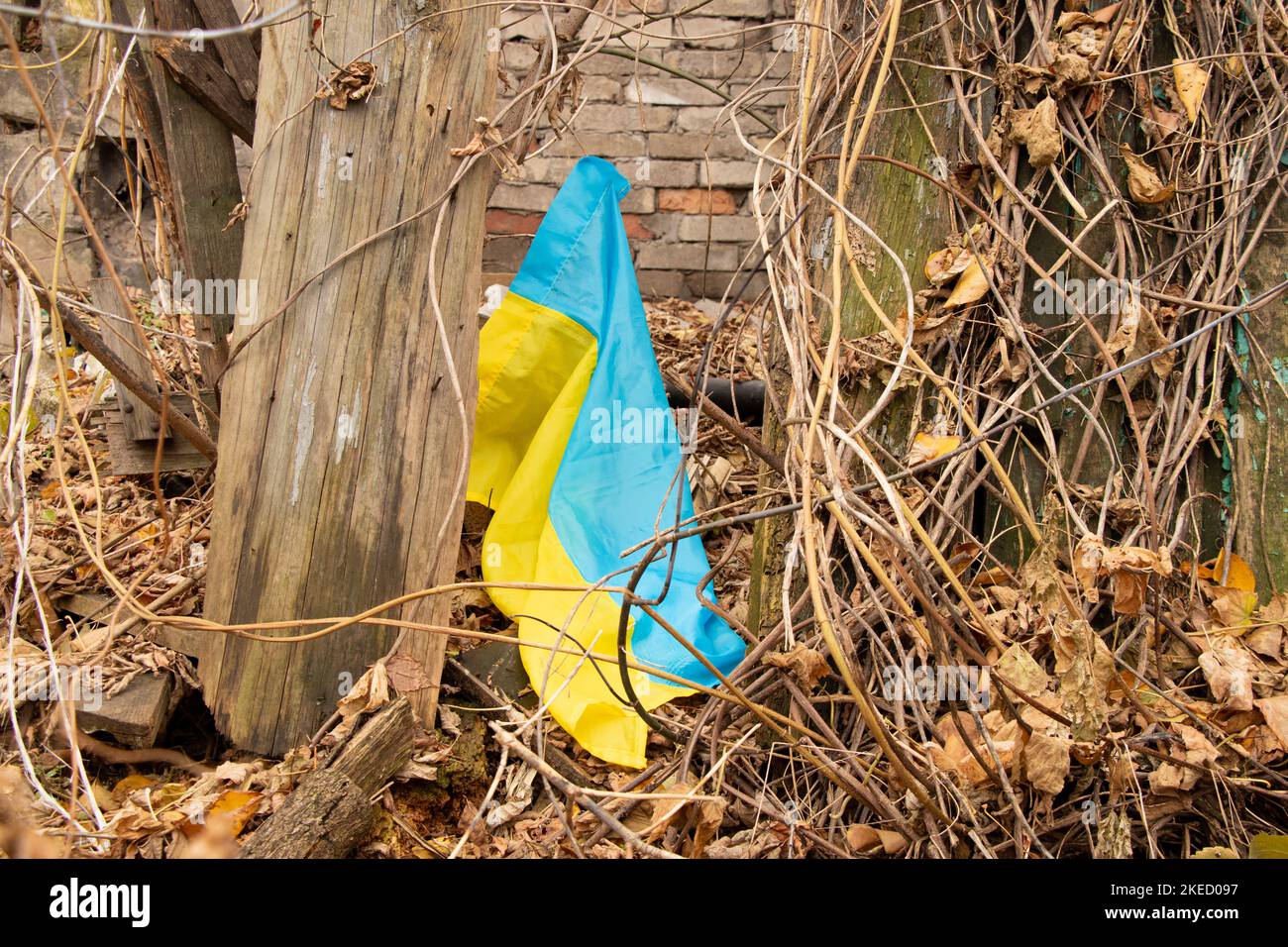 A residential building was blown up and the flag of Ukraine lies on the ...