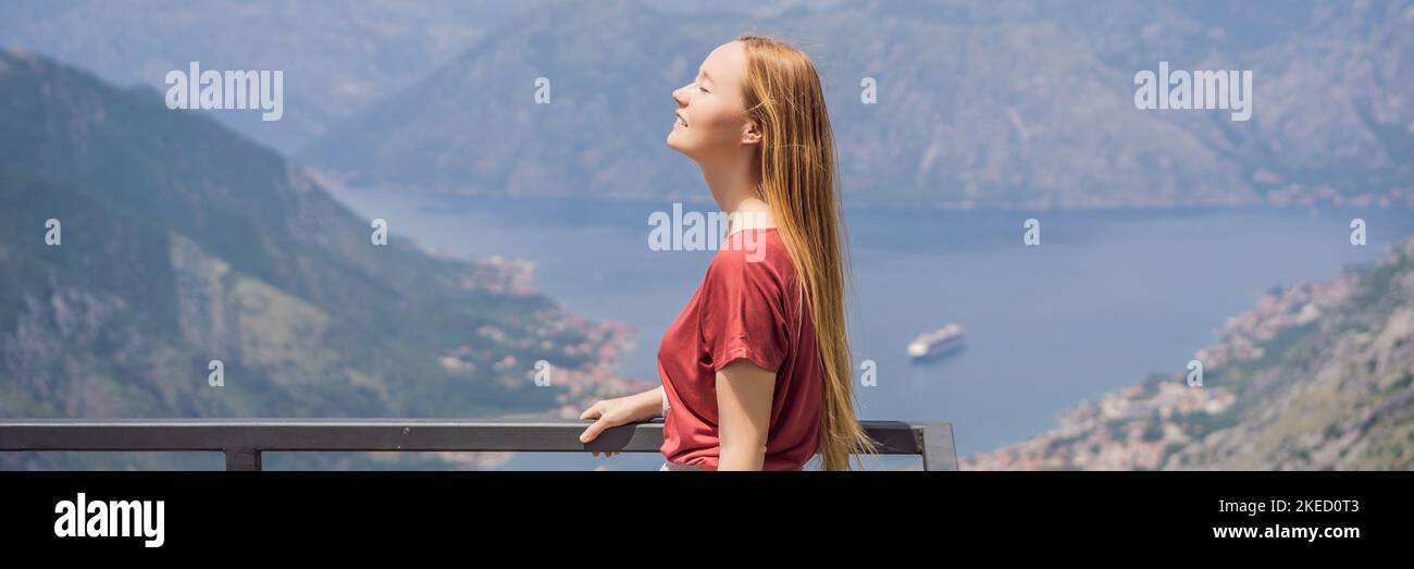 BANNER, LONG FORMAT Woman tourist enjoys the view of Kotor. Montenegro ...