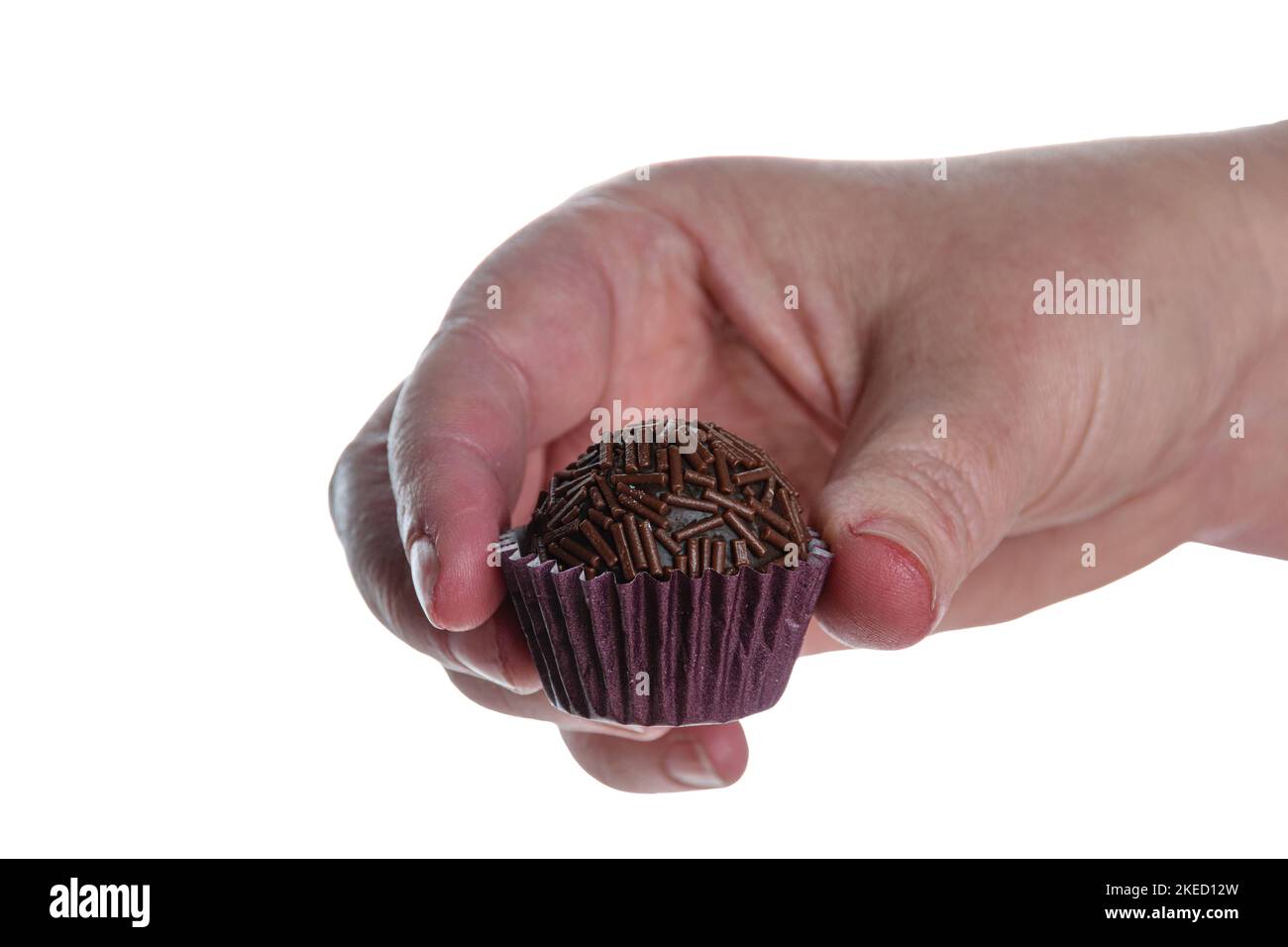 Confectioner holding a Brazilian fudge ball, Brazilian traditional ...