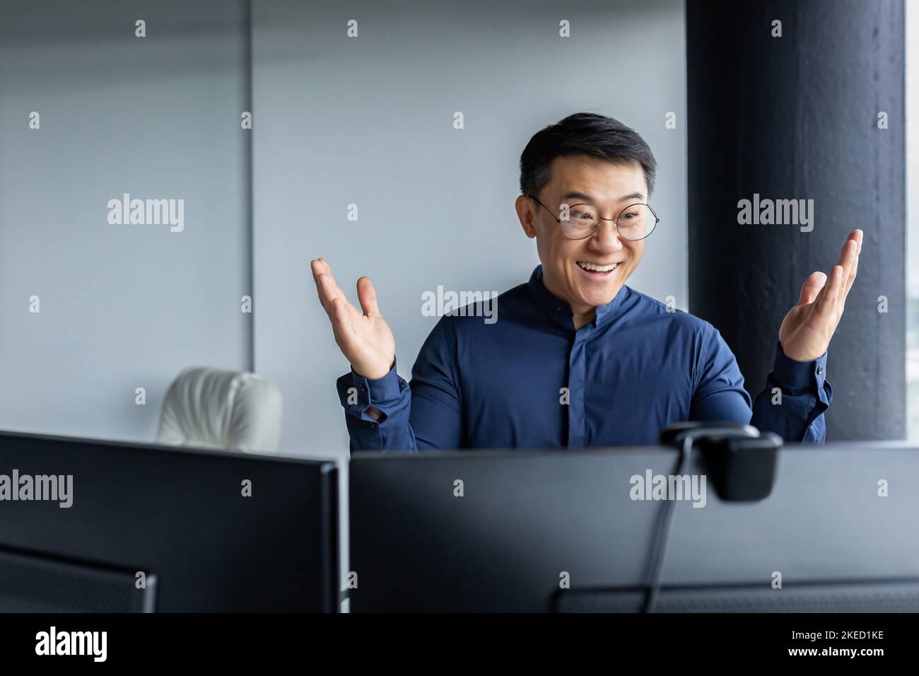 Online meeting with international partners. A happy young Asian ...