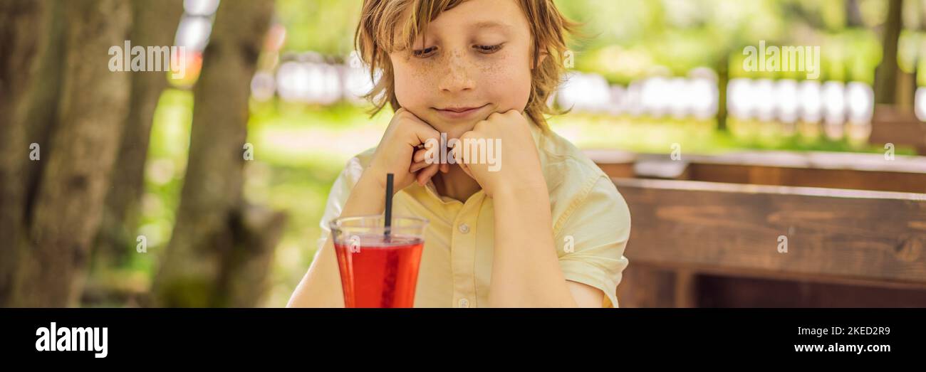 BANNER, LONG FORMAT Adorable little kid boy drinking healthy fruits and ...