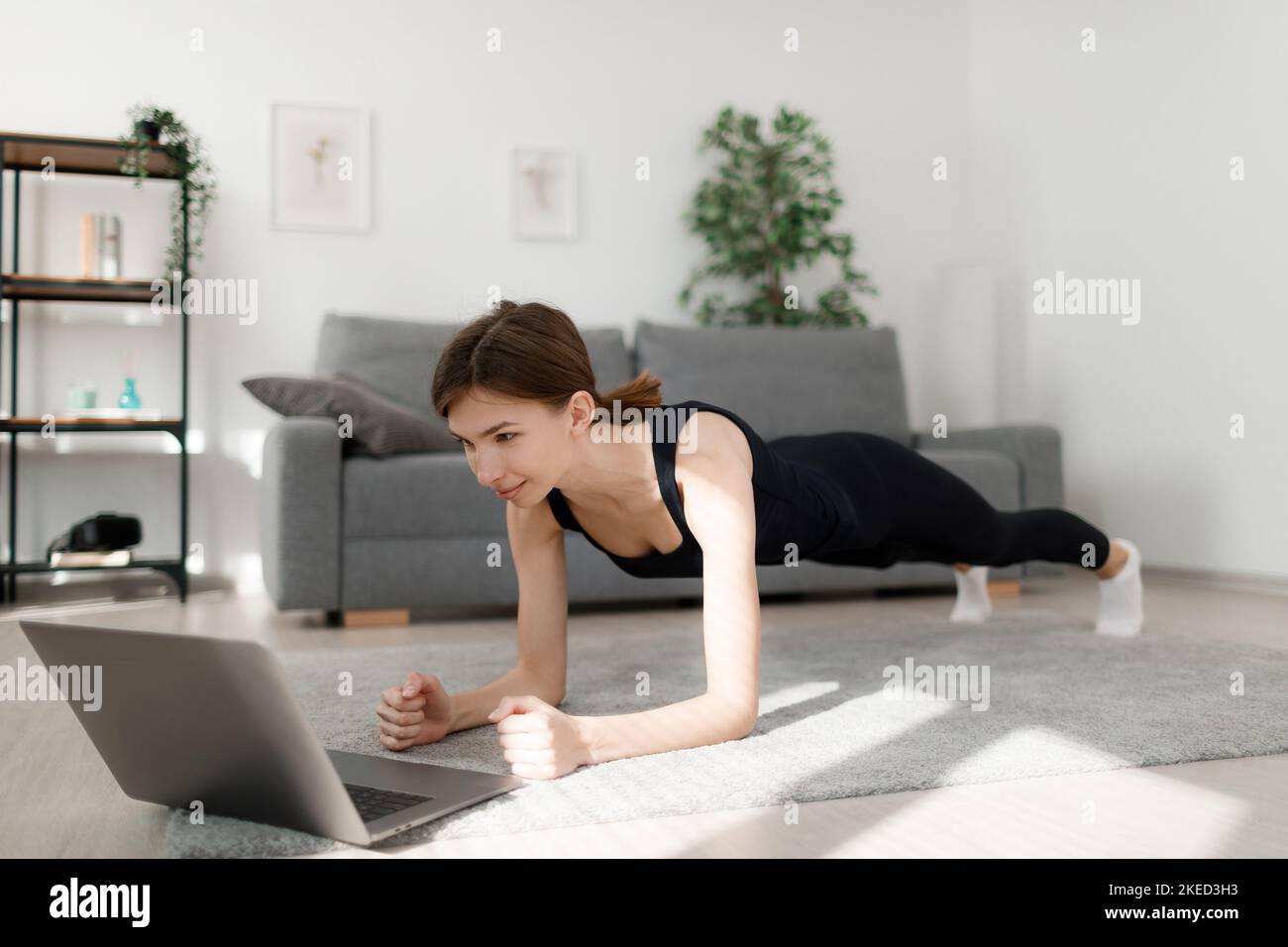 Woman training online with laptop Stock Photo - Alamy
