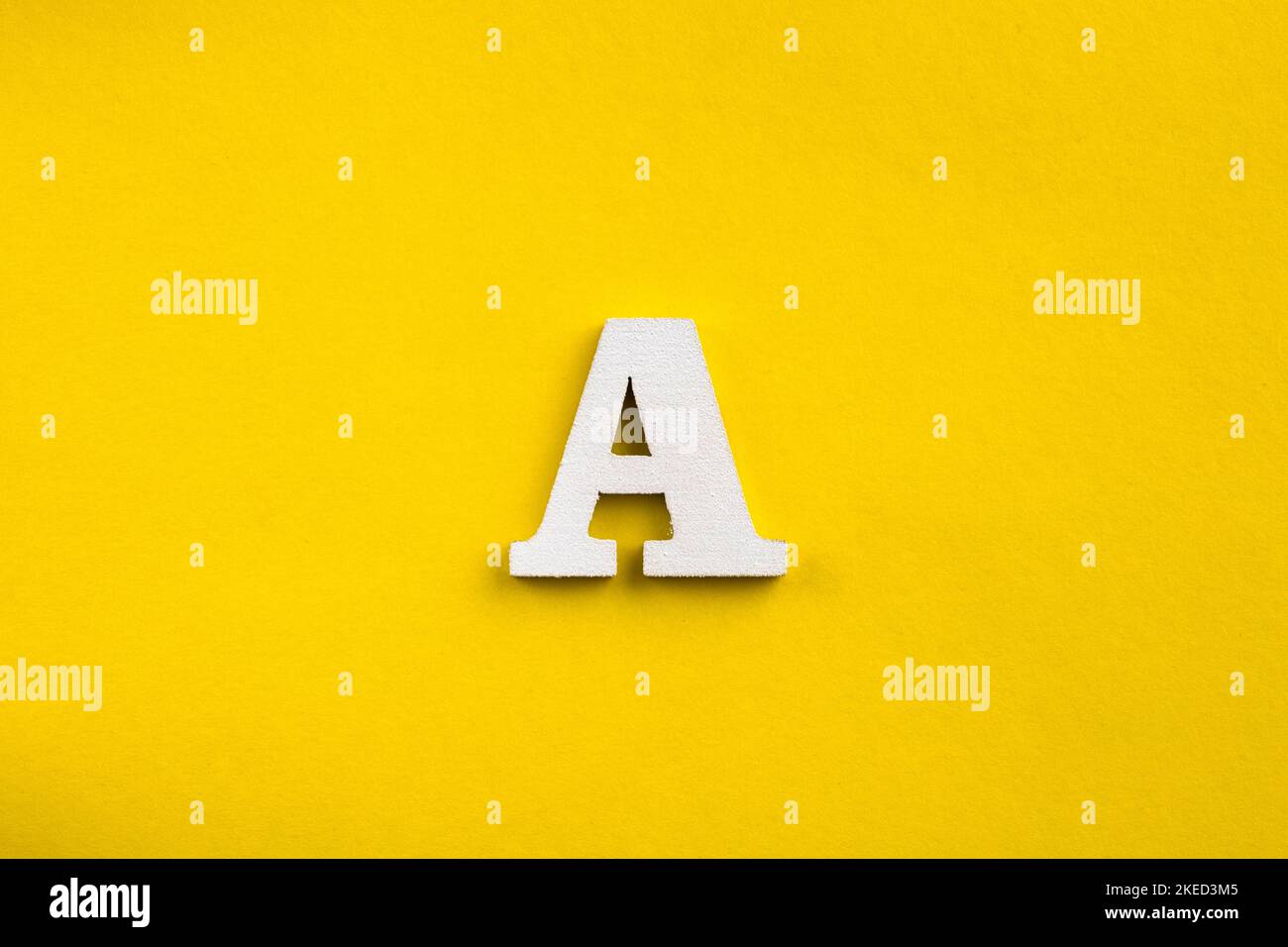 letter A uppercase - white wood letter on yellow color background Stock ...