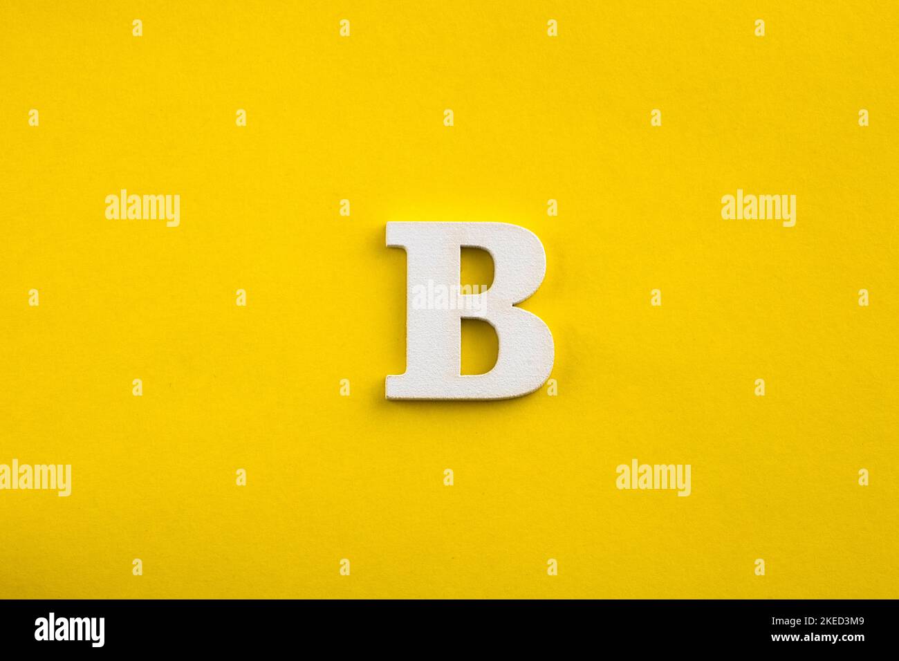 Alphabet letter B - White wood letter on yellow colored background ...