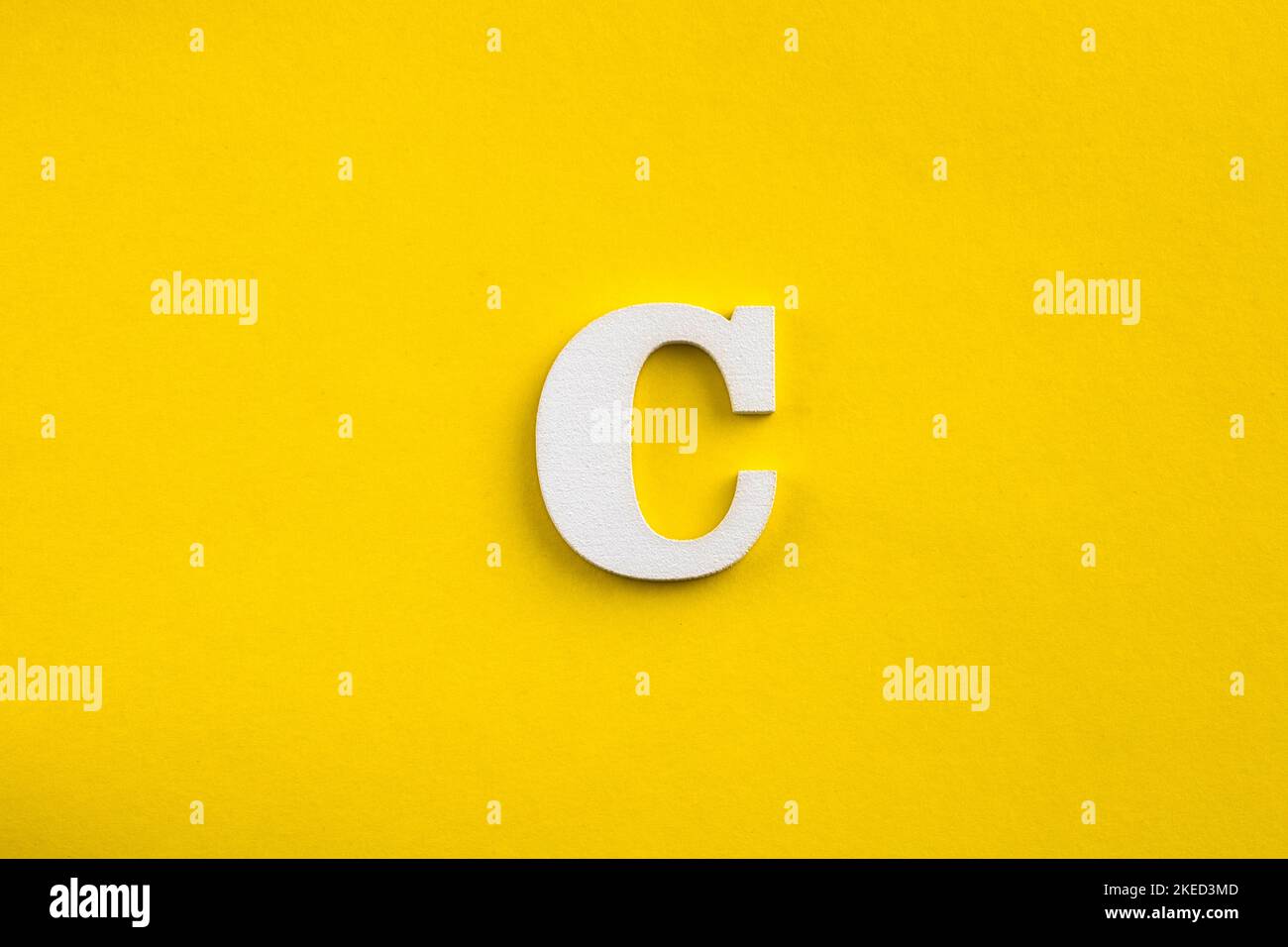 letter C uppercase - white wood letter on yellow color background Stock ...